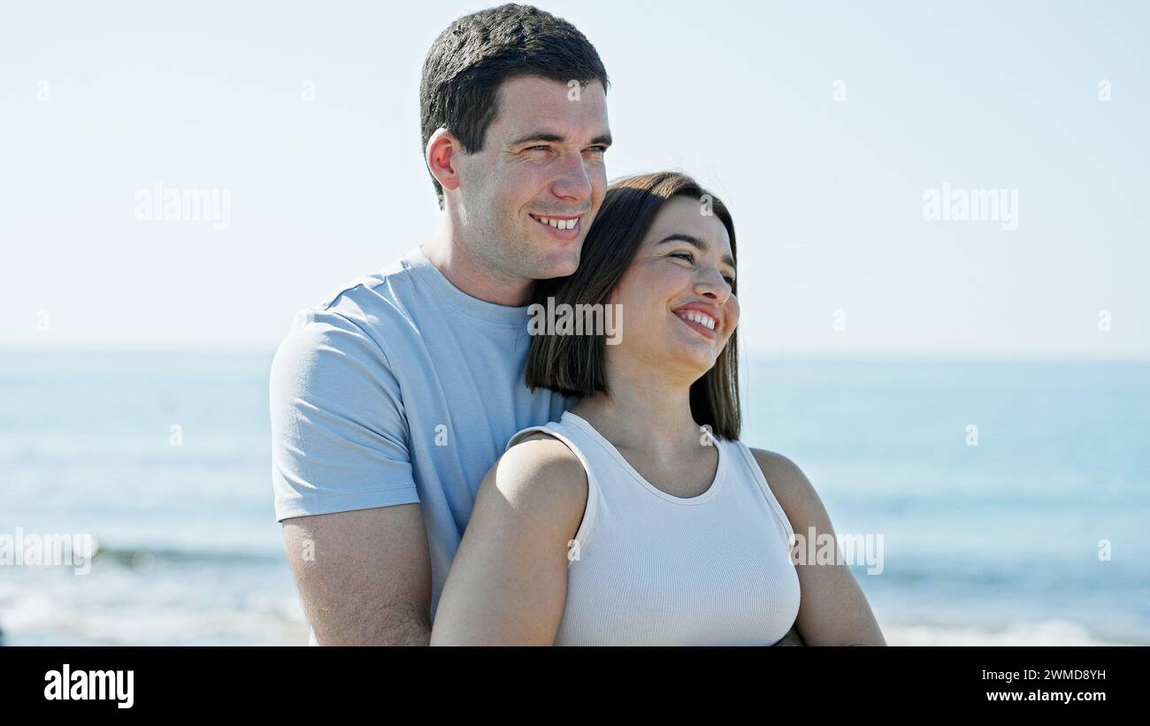 Beautiful couple smiling confident hugging each other at seaside Stock ...