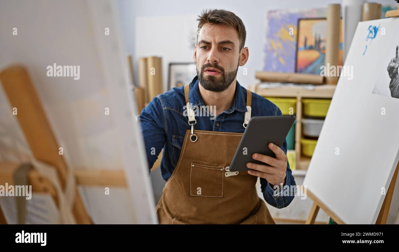 Passionate young hispanic man artist immersed in painting class ...