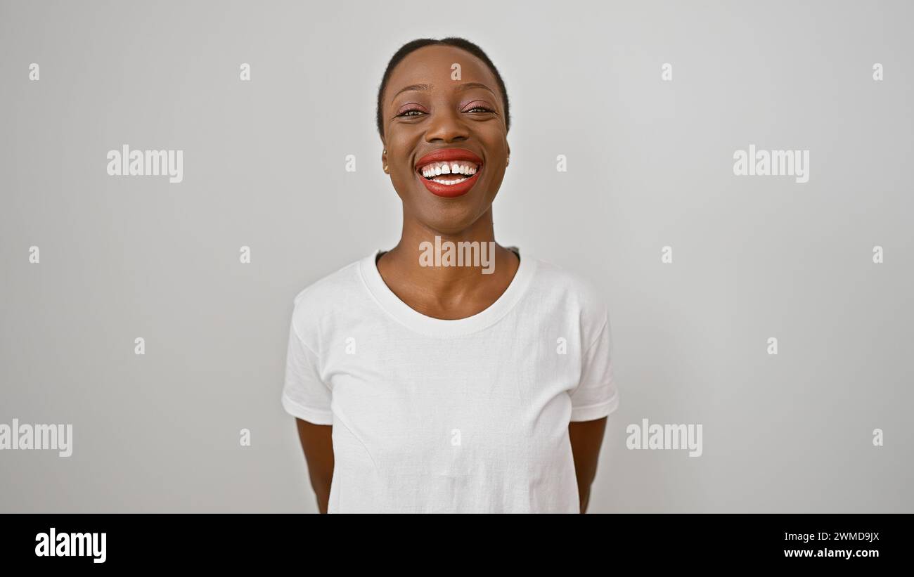 Confident african american woman joyfully smiling and standing against ...