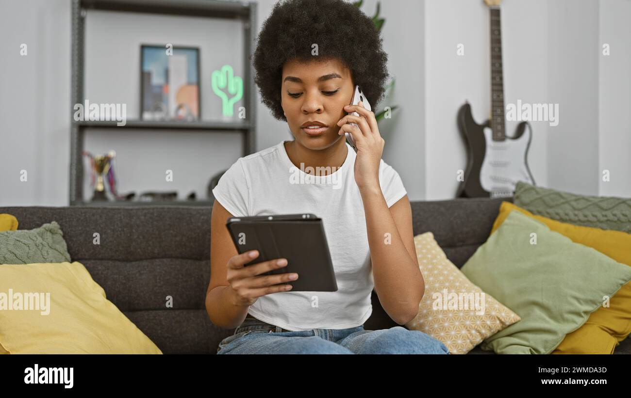 An african american woman multitasking at home, talking on the phone ...
