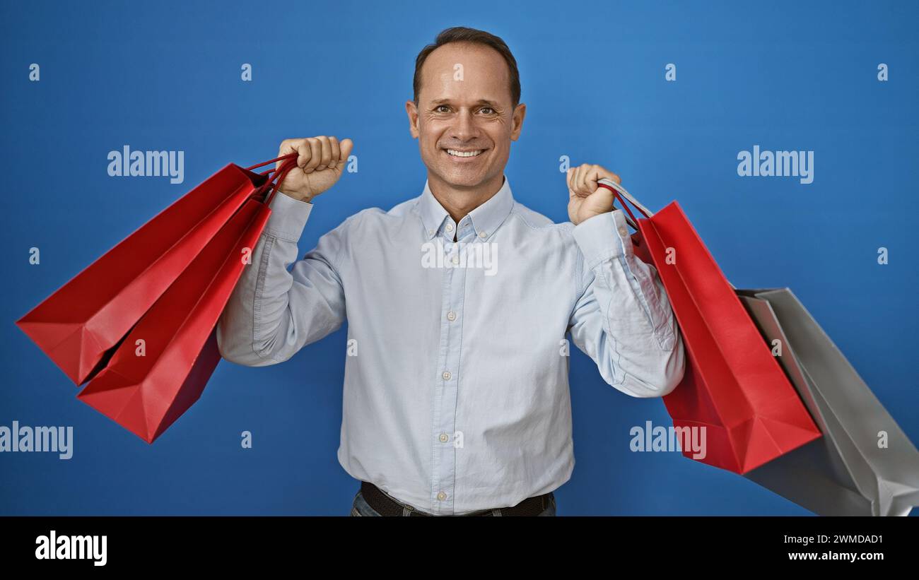 Joyful middle age man, shopper in his happiness, flaunting style with ...