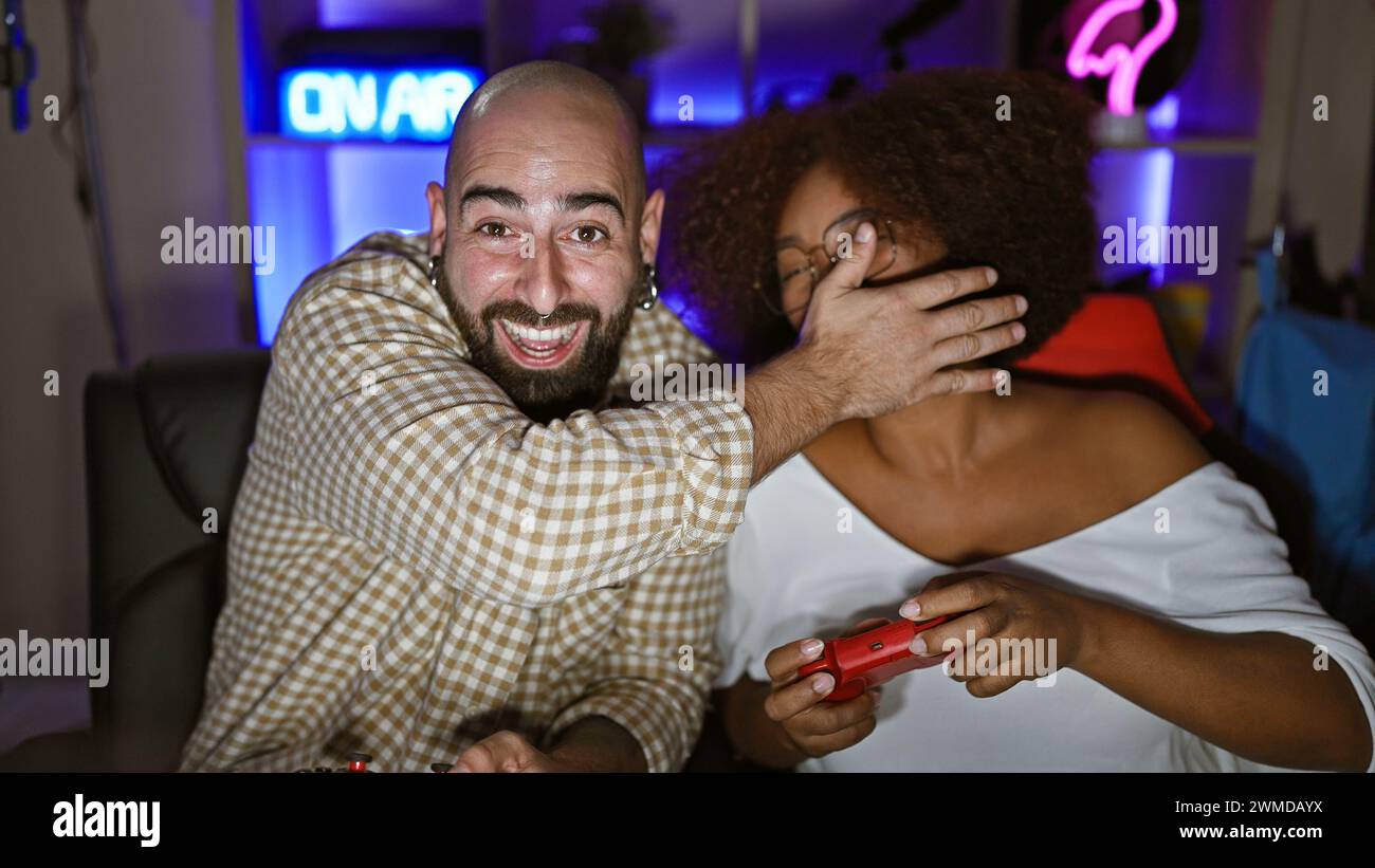 Two laughing gamers, man and woman, confidently streaming their game ...