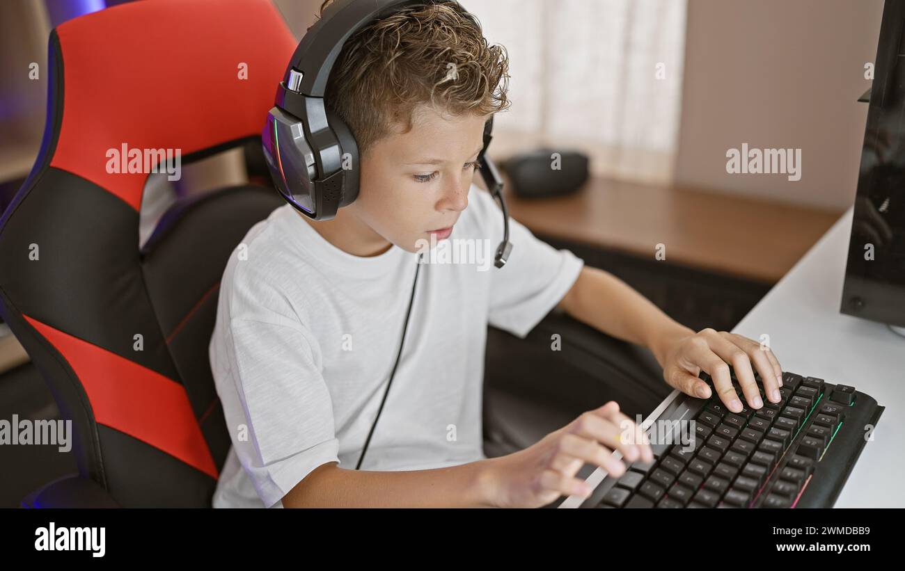 Blond boy streamer playing video game using computer at gaming room ...