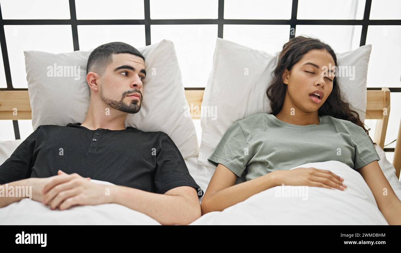 Exhausted, beautiful couple suffering from insomnia together, waking at ...