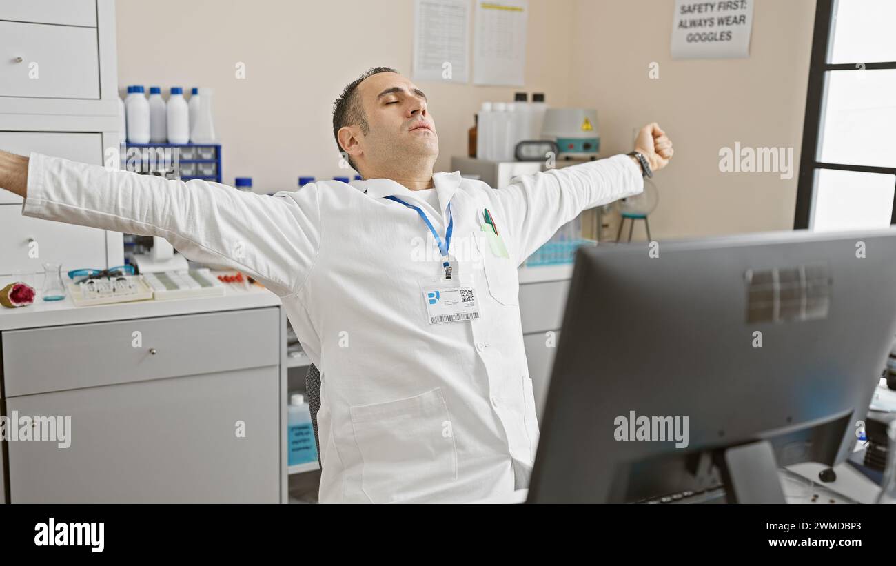Tired male scientist stretching in a laboratory setting, showcasing ...
