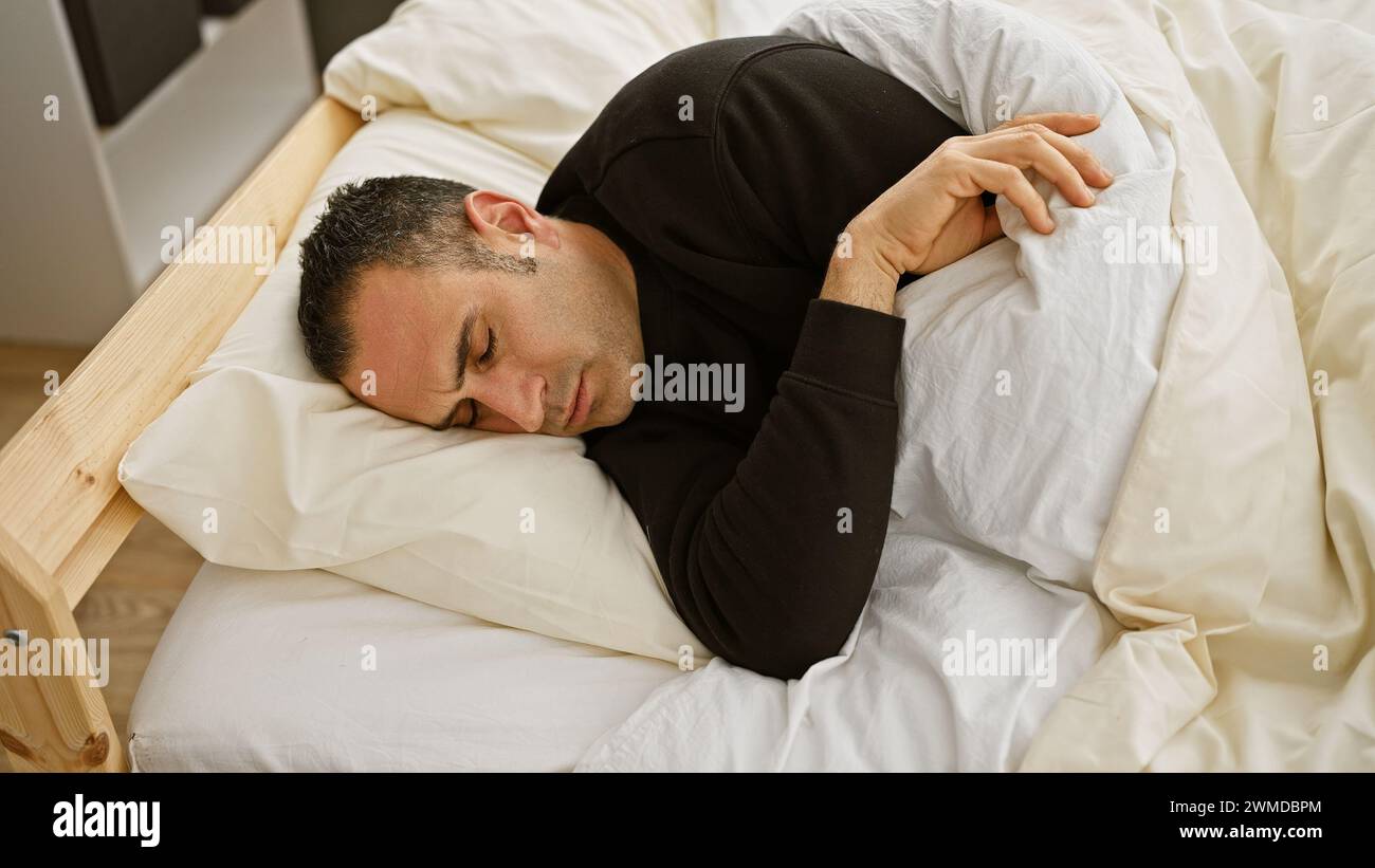 Hispanic man sleeping peacefully in a comfortable bedroom setting ...