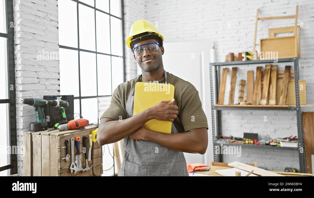 A confident young african american man wearing a hard hat and safety ...