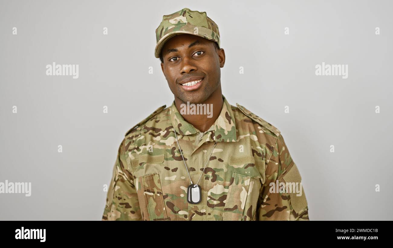 Smiling african american soldier in camouflage uniform posing against ...