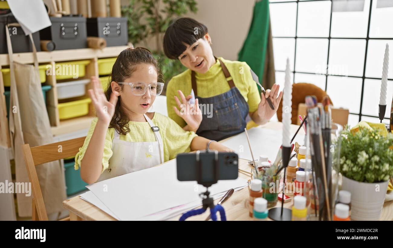 Cheerful student and her art teacher-artist engage in drawing lesson ...