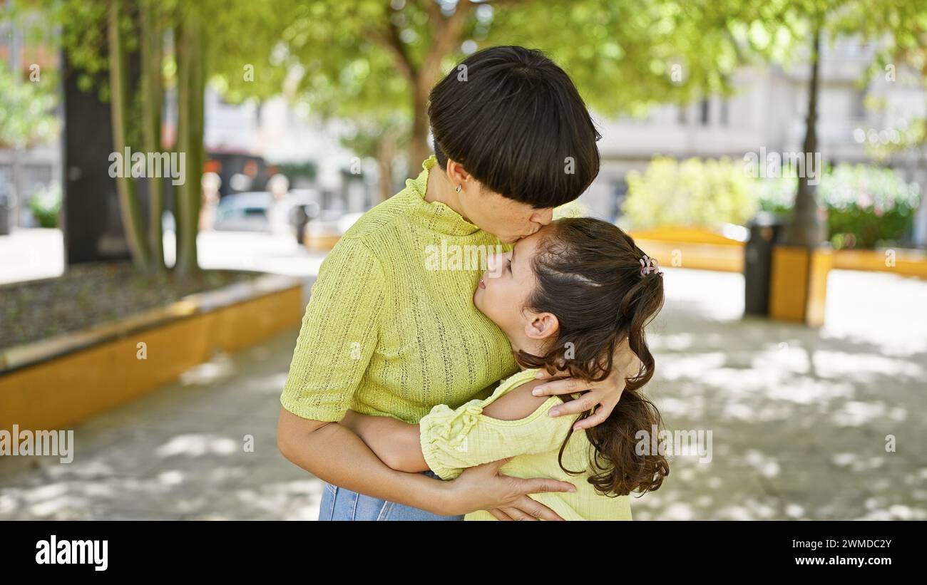A beautiful sunny day at the park, a lovely mother and daughter ...