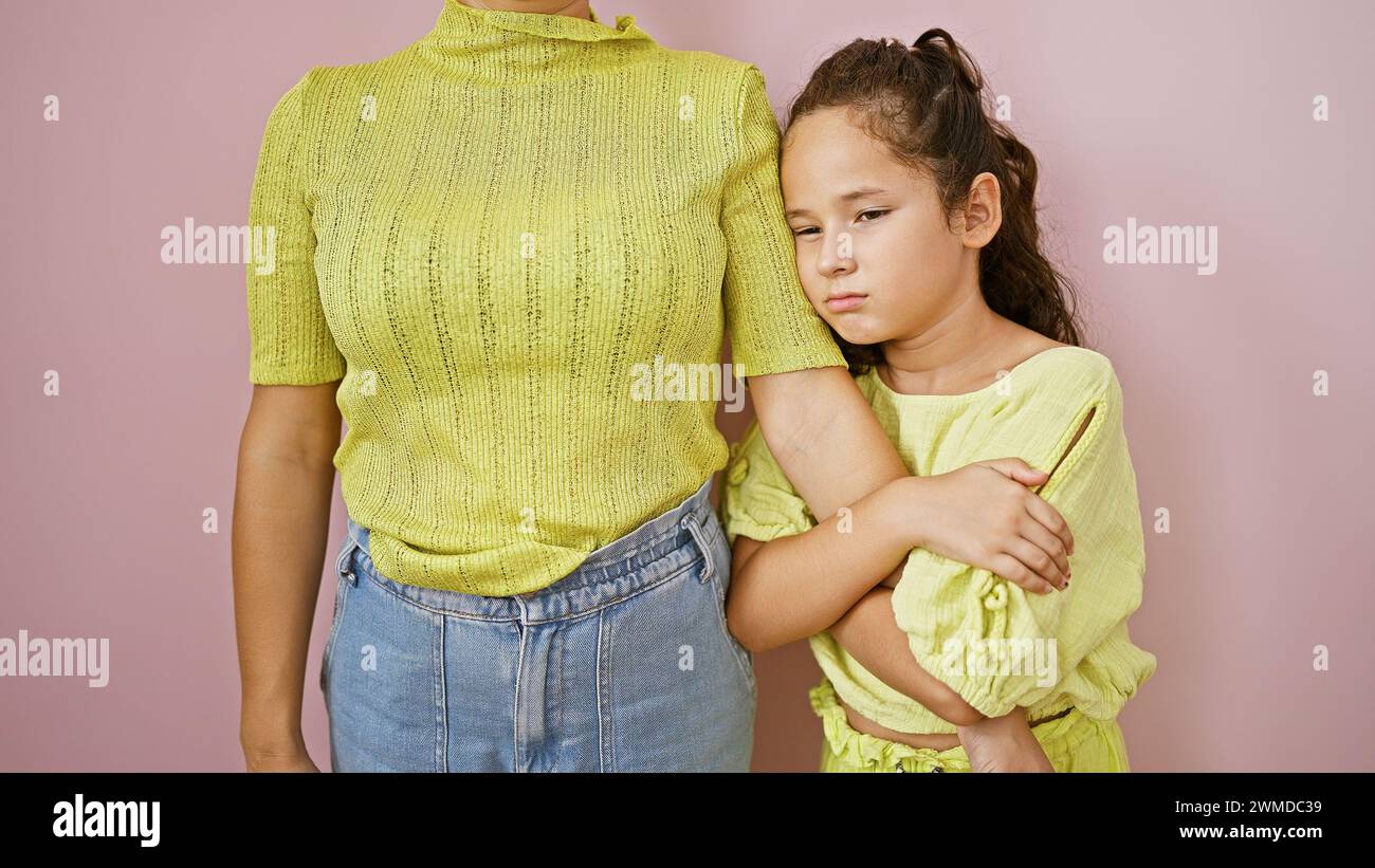 Lovely mother and daughter embracing in a warm hug, standing over a ...