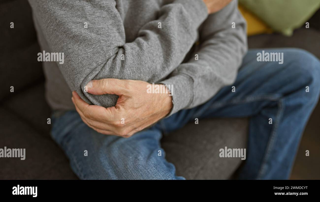 Mature man experiencing elbow pain hi-res stock photography and images ...