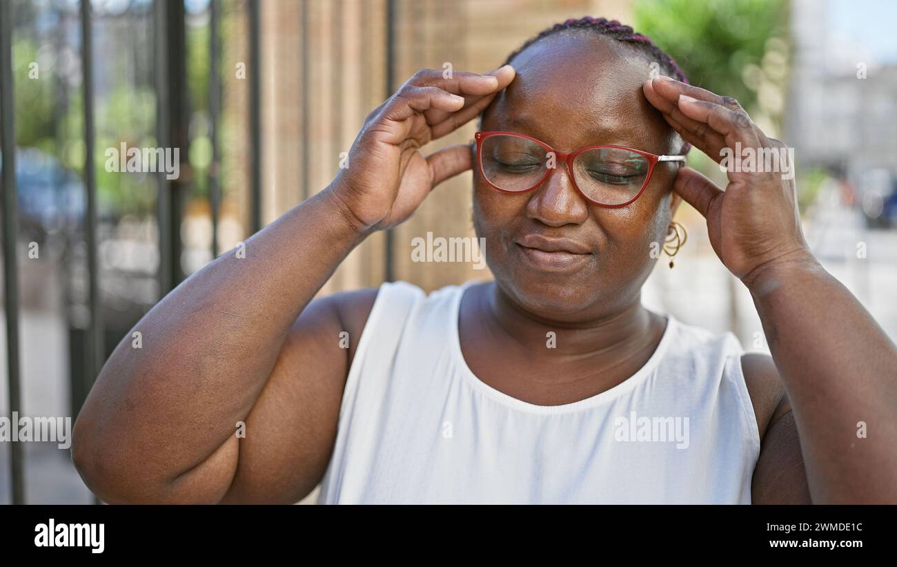 Stressed african american woman with braids, feeling headache ache on ...
