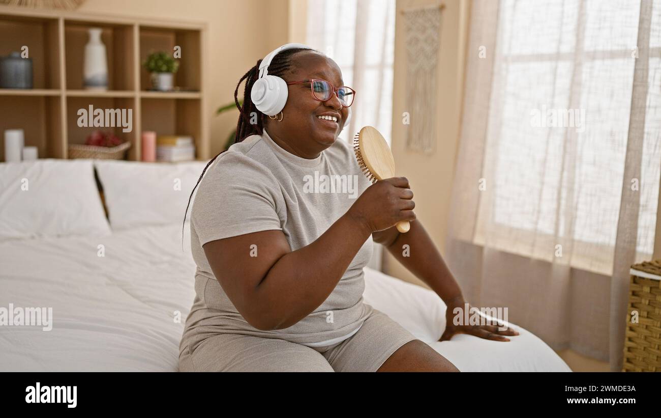 Confident african american woman enjoying morning, relaxing on bed ...