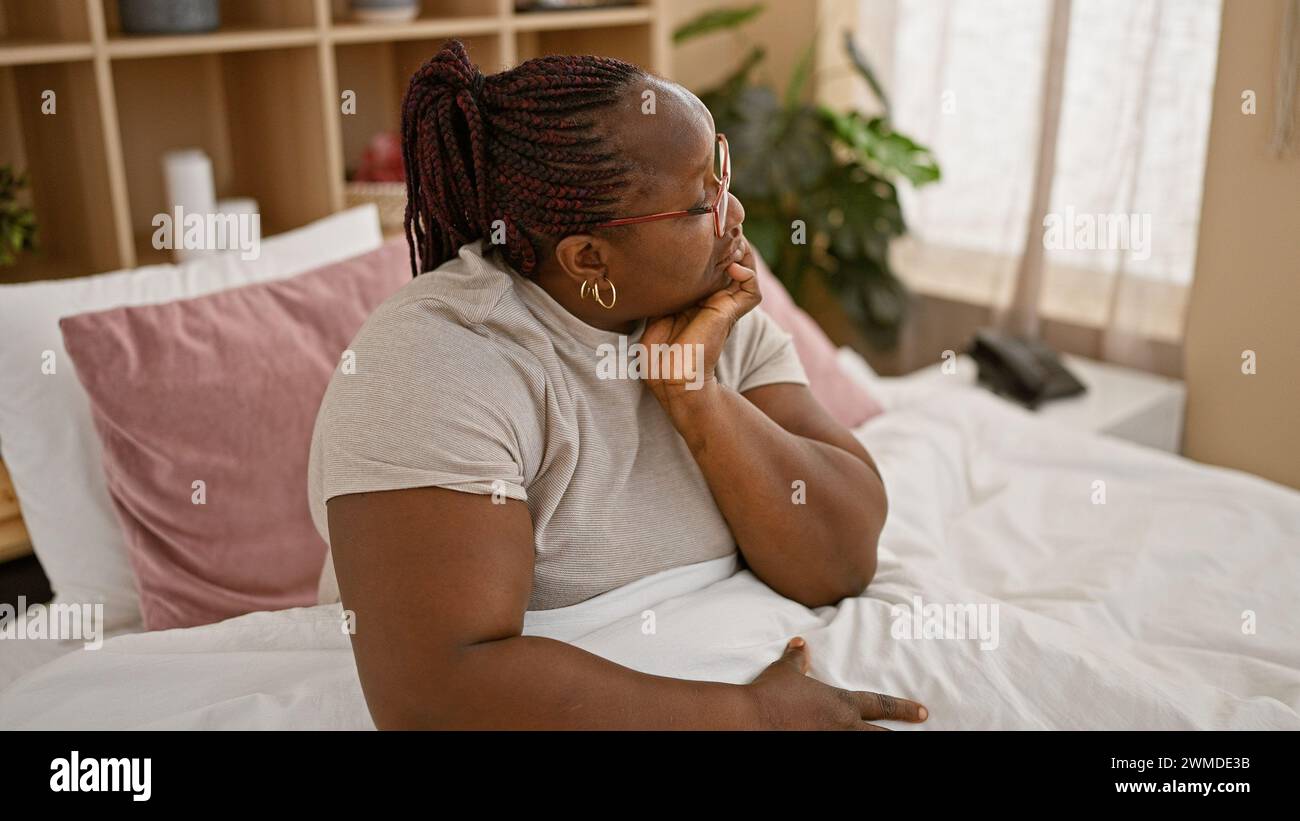Plus-sized african american woman with braids, looking overwhelmed by ...