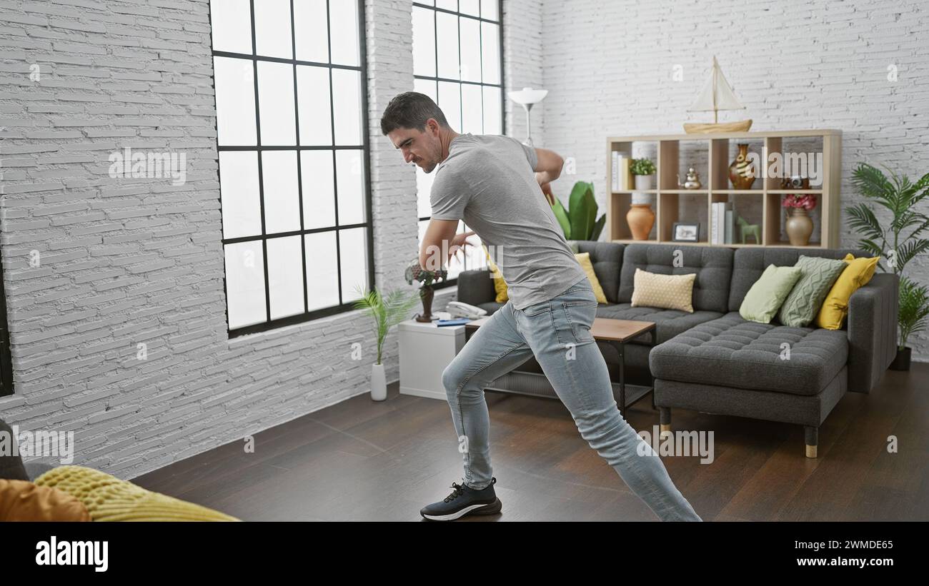 Handsome young man dancing alone in a stylish modern living room ...