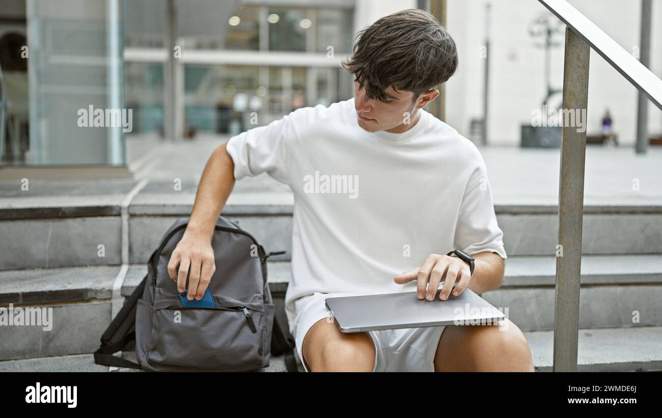 Cool young hispanic student chilling on university stairs, phone in ...