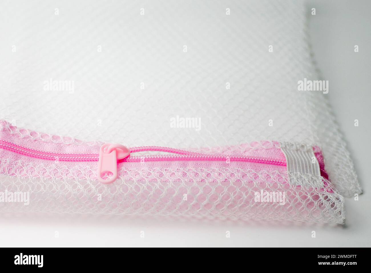 Half open pink zipper on mesh fabric isolated on white background Stock ...