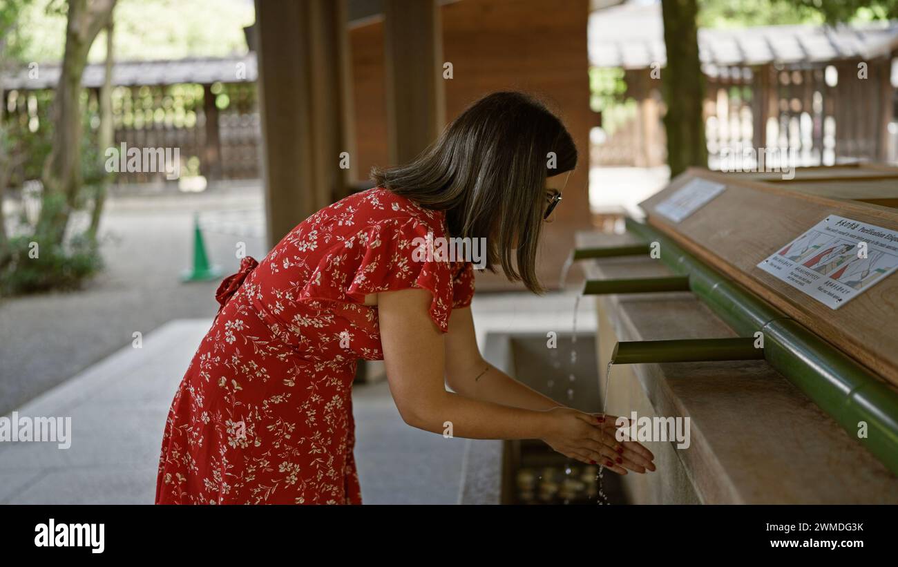 Beautiful hispanic woman with glasses participates in traditional asian ...