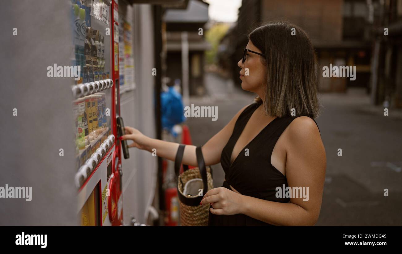 Beautiful hispanic woman with glasses uses phone to buy from kyoto's ...