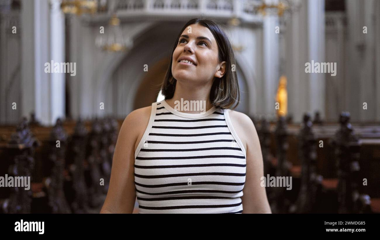 Young beautiful hispanic woman visiting church at Augustinian Church in ...