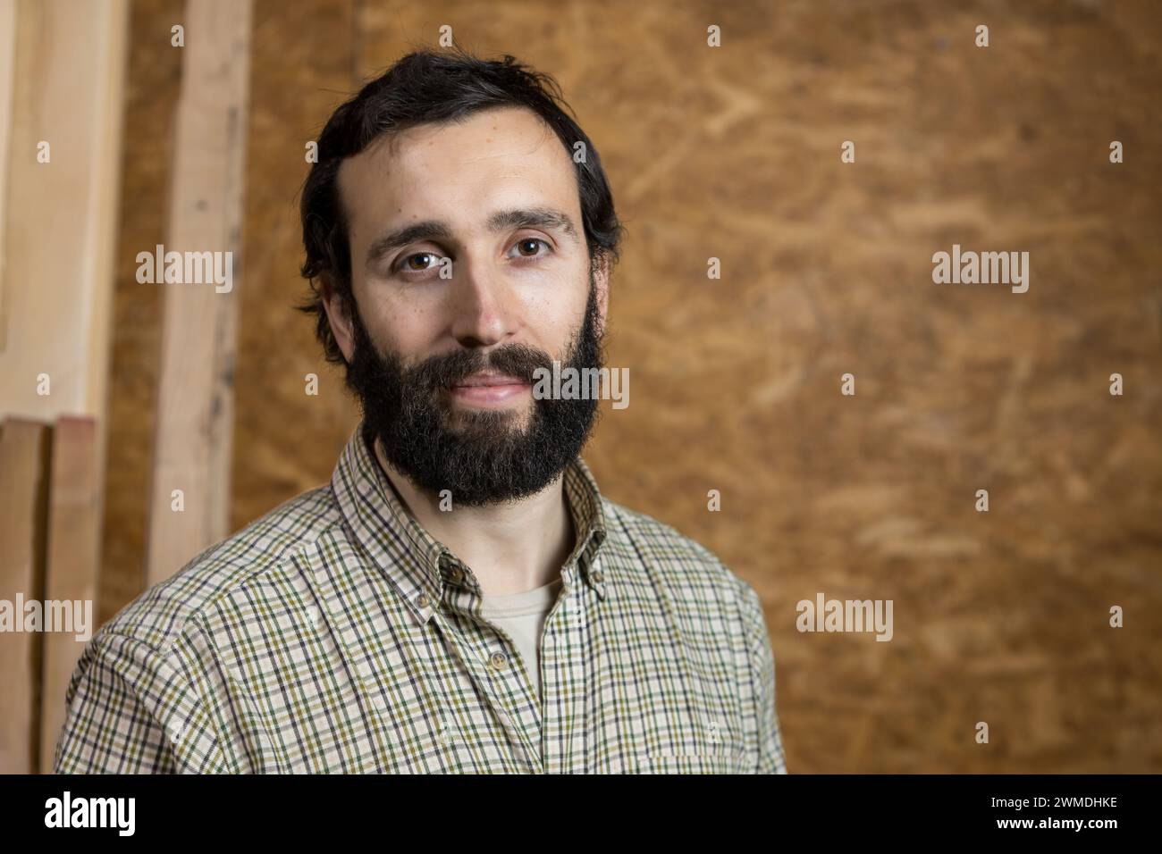 Horizontal photo a warm portrait of a bearded man in a plaid shirt ...