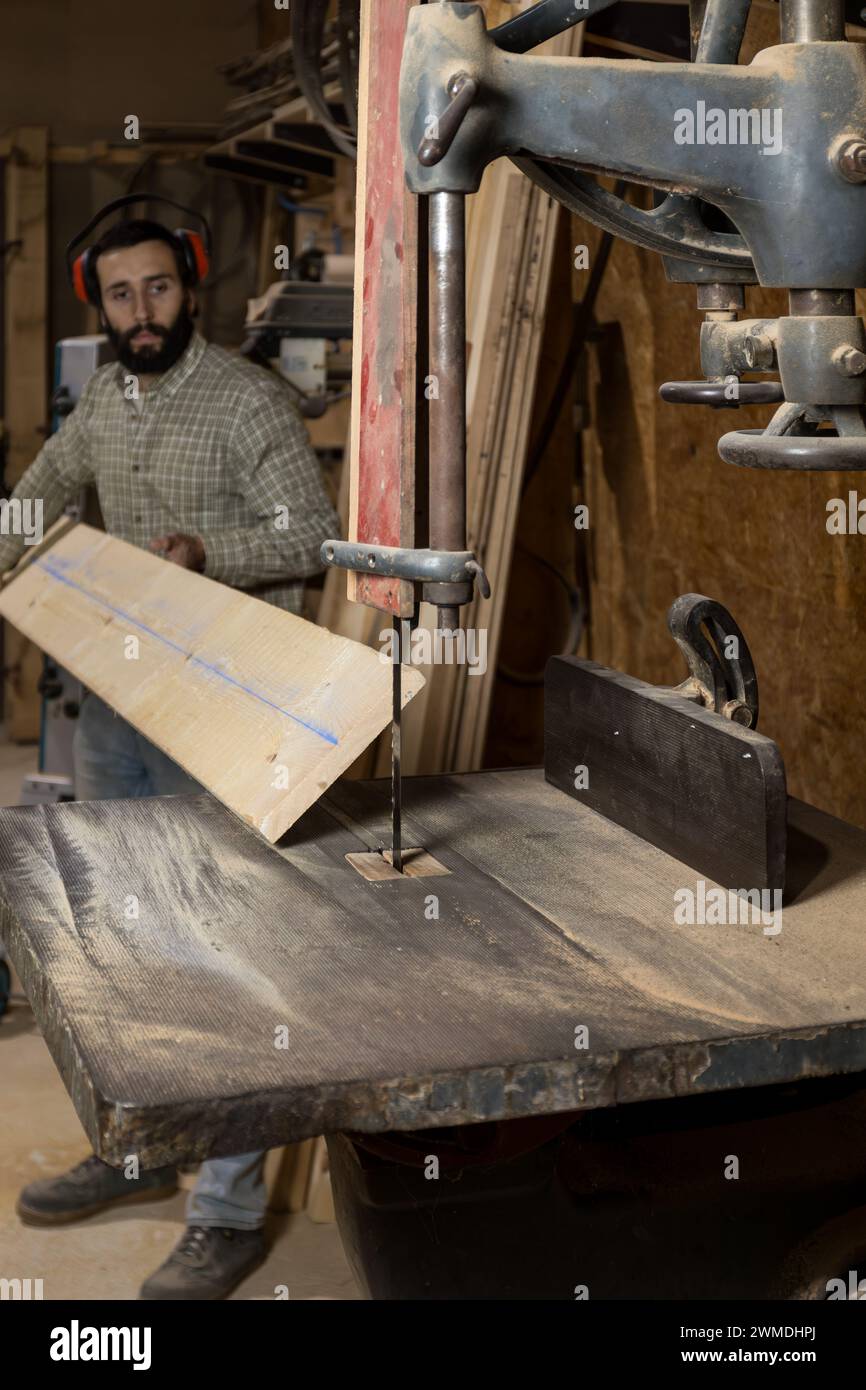 Vertical photo a man mid adult caucasian carpenter with protective ear ...