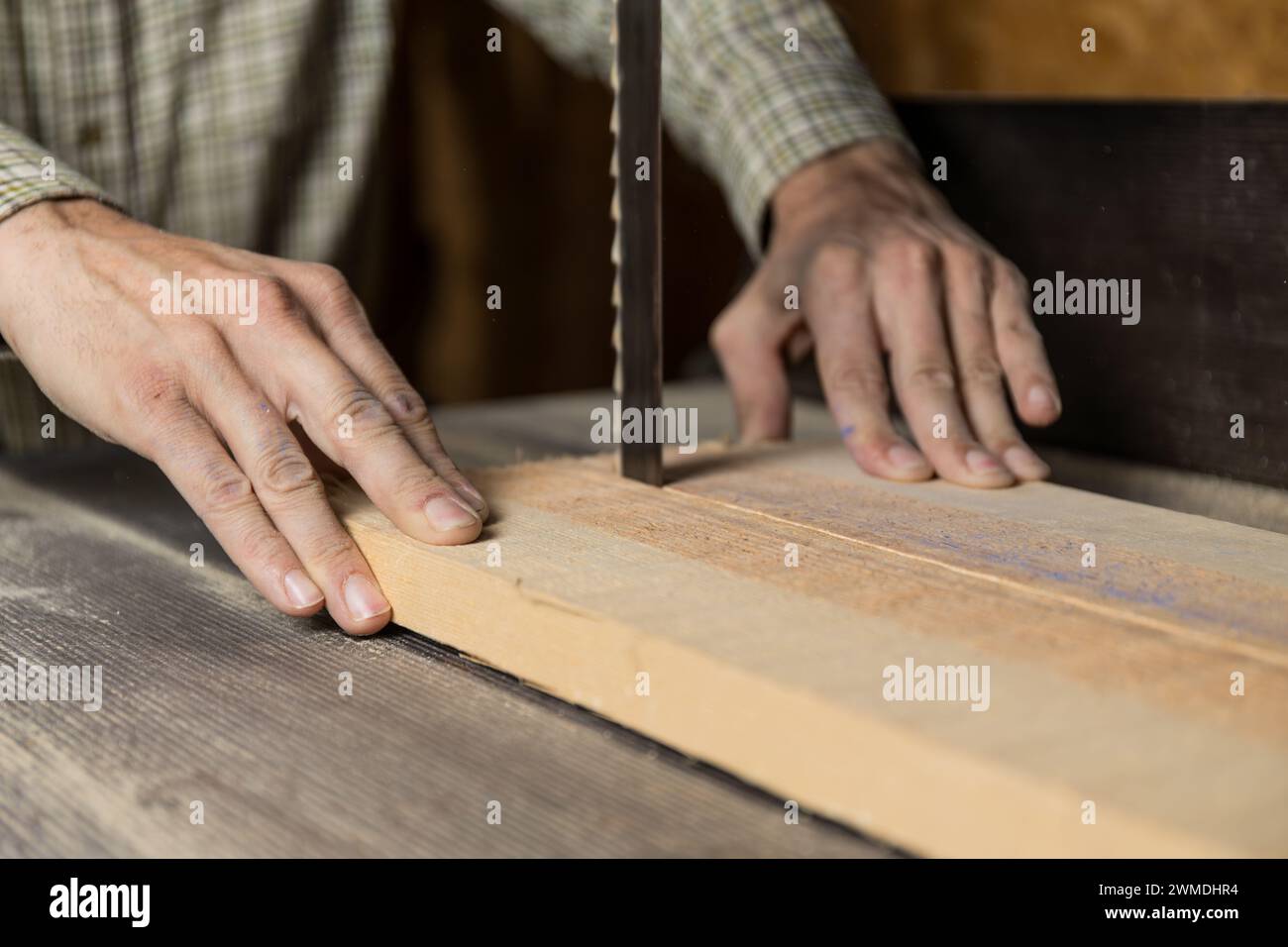 Horizontal photo a focused shot capturing a carpenter's hands as they ...