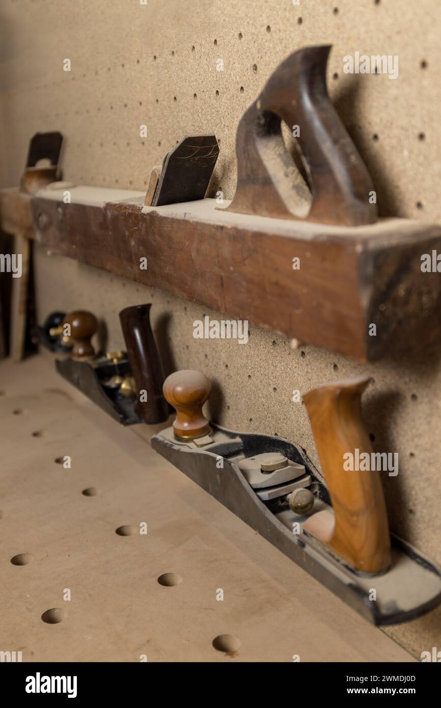 Vertical photo a collection of classic wooden hand planes rests on a ...
