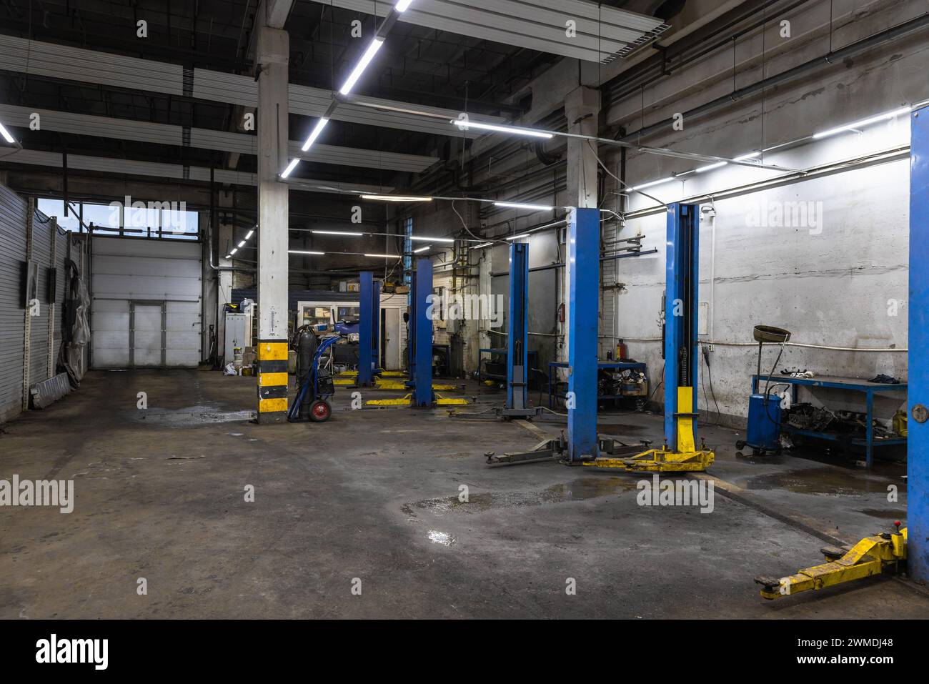Car service interior with concrete pillars and car lifts Stock Photo ...