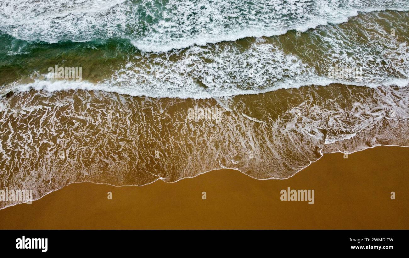 Ocean waves rolling in on a sandy beach for surfing Stock Photo - Alamy