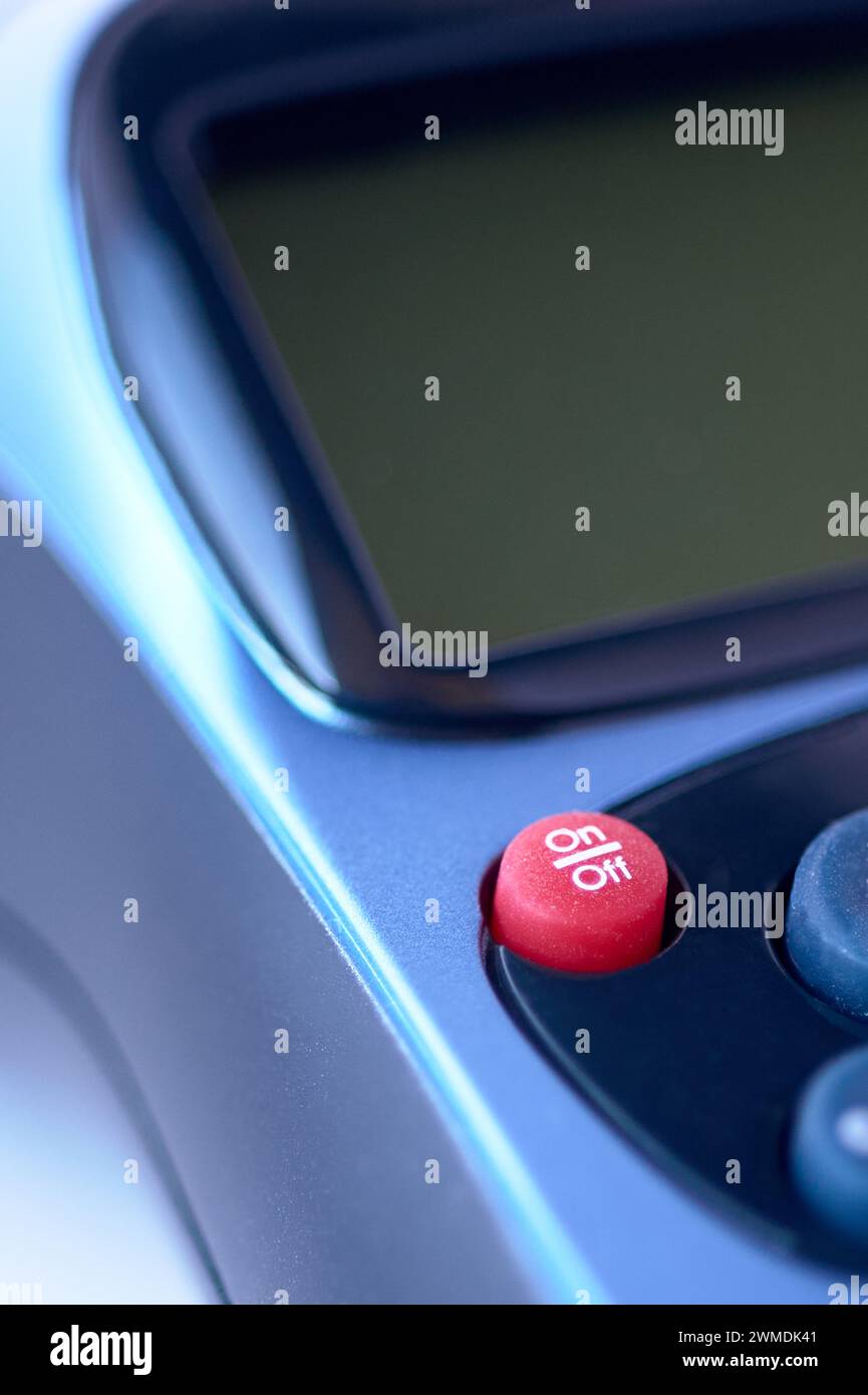 Close-up of a red on/off button, part of a modern electronic device ...