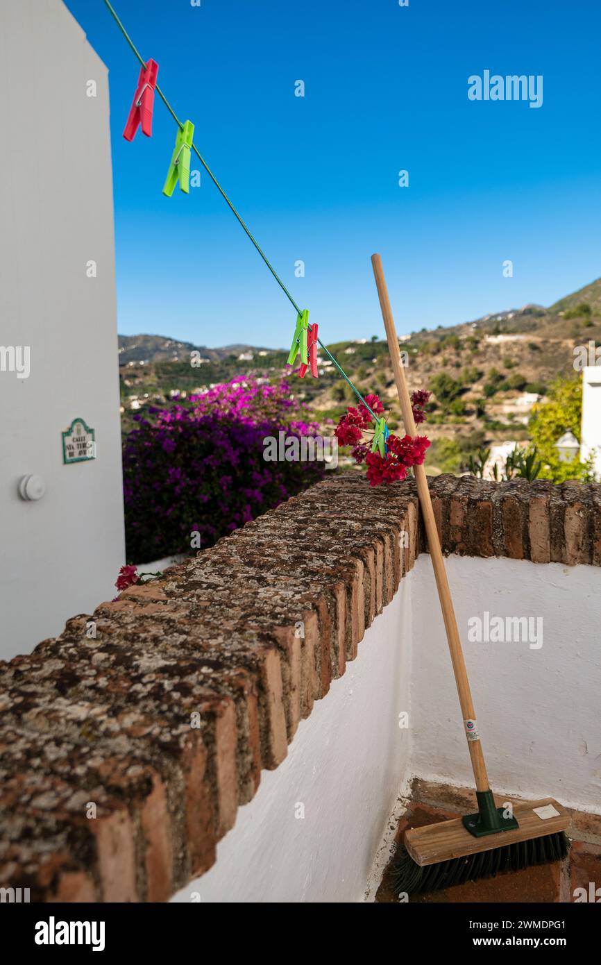 Typical Andalusian corner. Rope and stick rest next to a broom ...