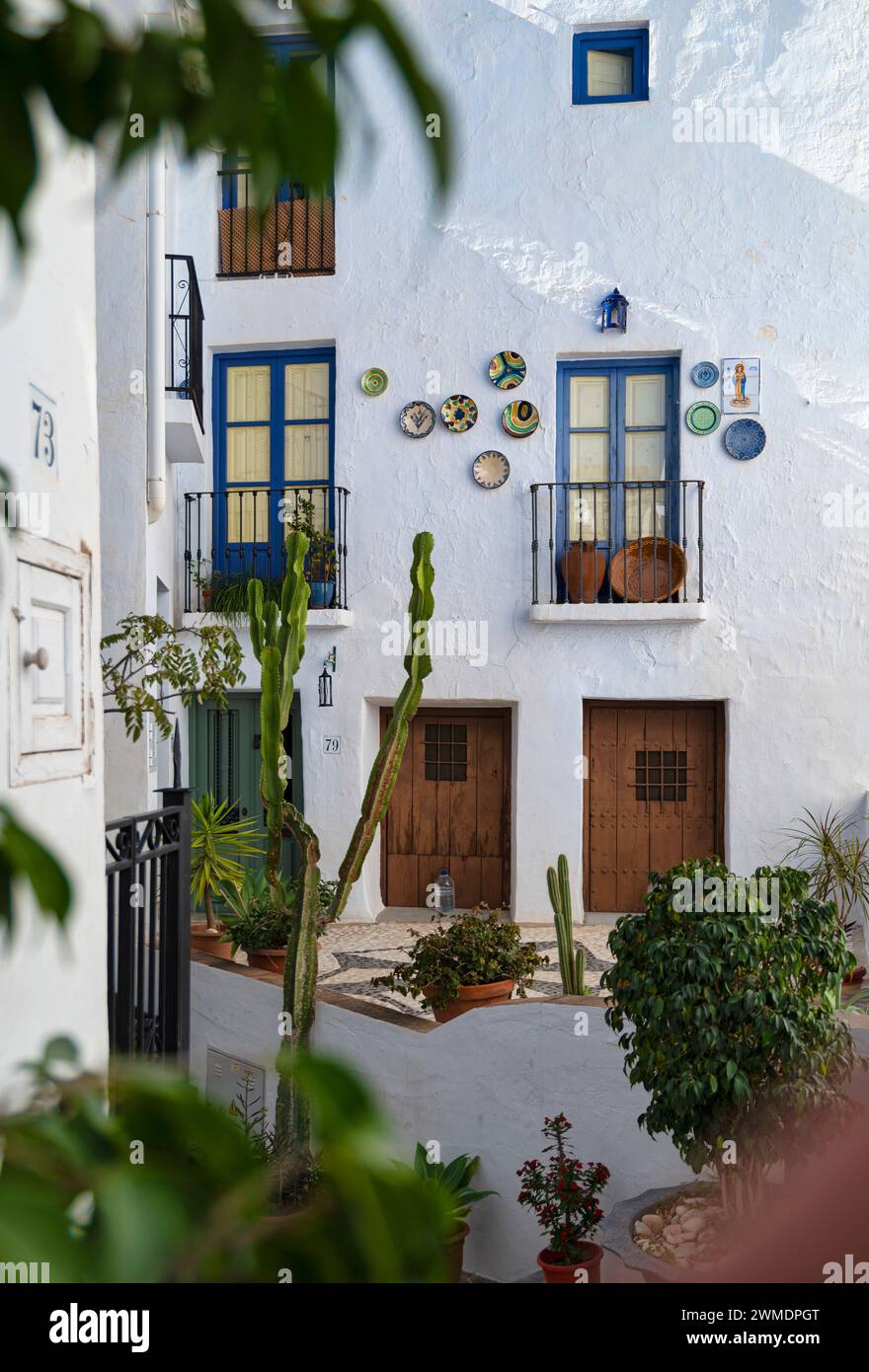 Blue door and windows adorn the serene facade of yesteryear Stock Photo ...