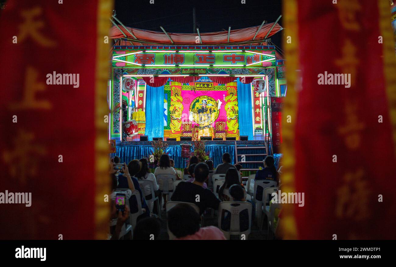 People watch Chinese opera performance during the birthday celebration ...