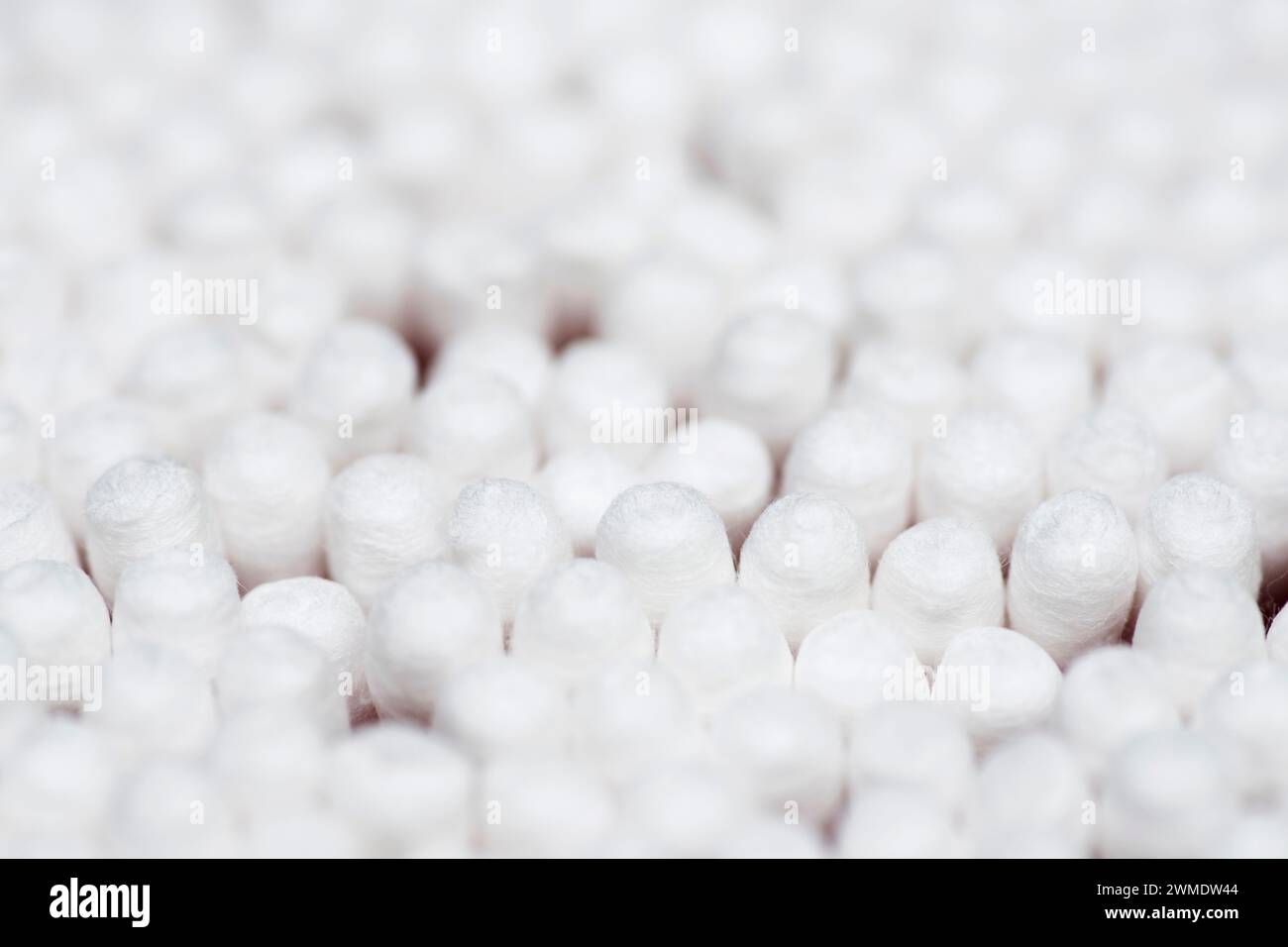 Many white cotton sticks. Round container with cotton buds Stock Photo ...