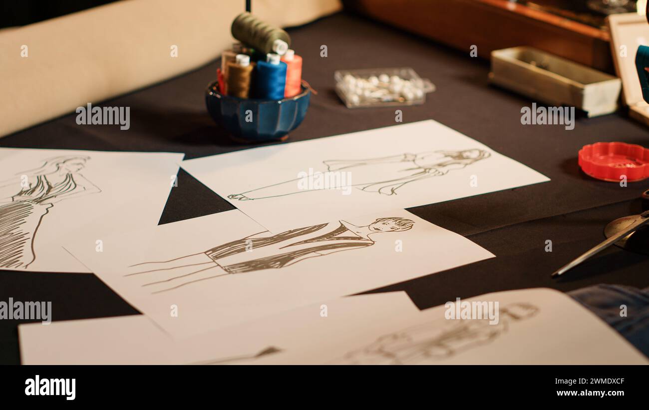 Tailoring sketches to design clothes on atelier workstation, drawings ...