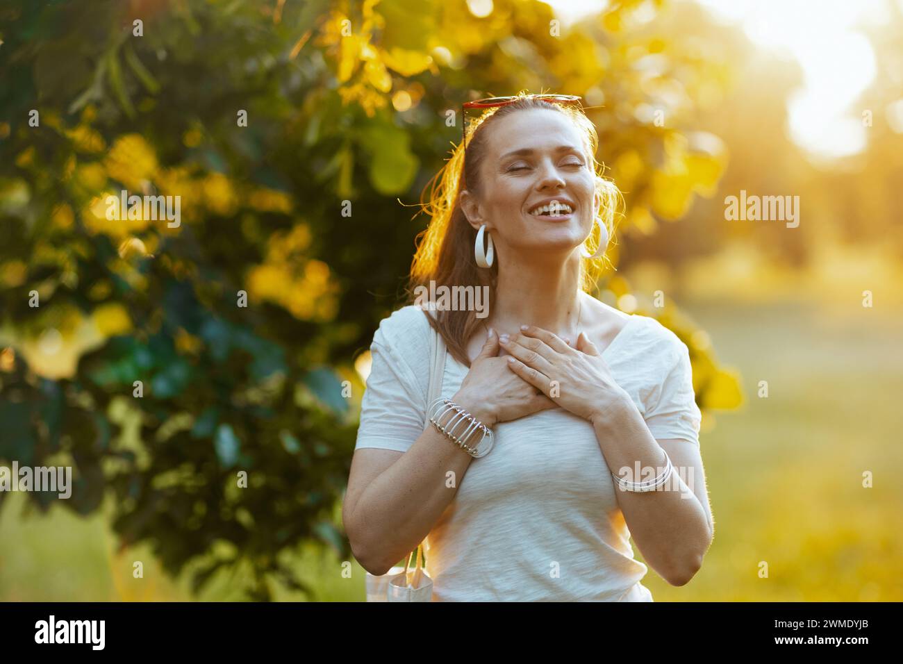 Hand on chest woman happy hi-res stock photography and images - Alamy