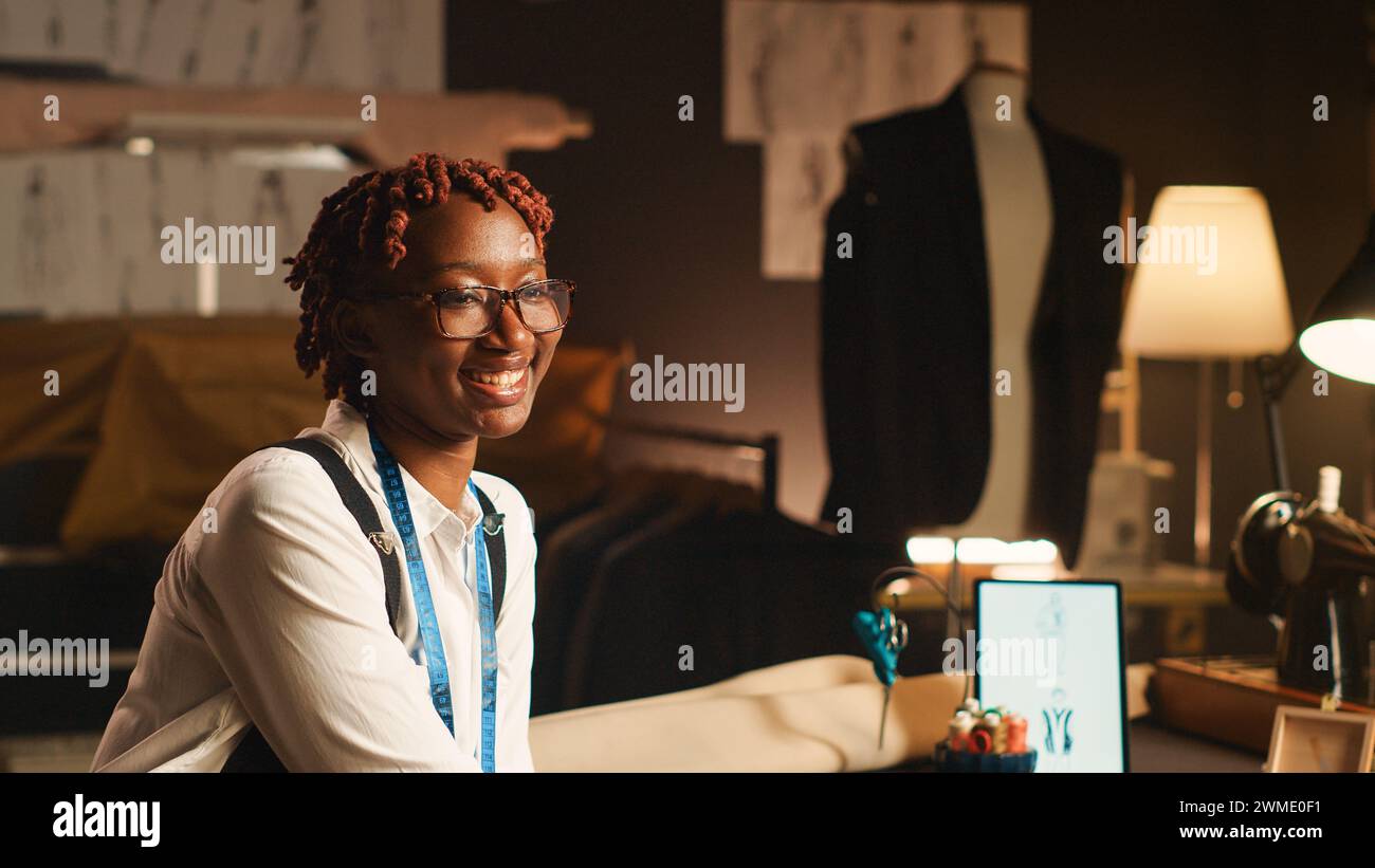 African american tailor using fabric in sewing shop, seamstress ...