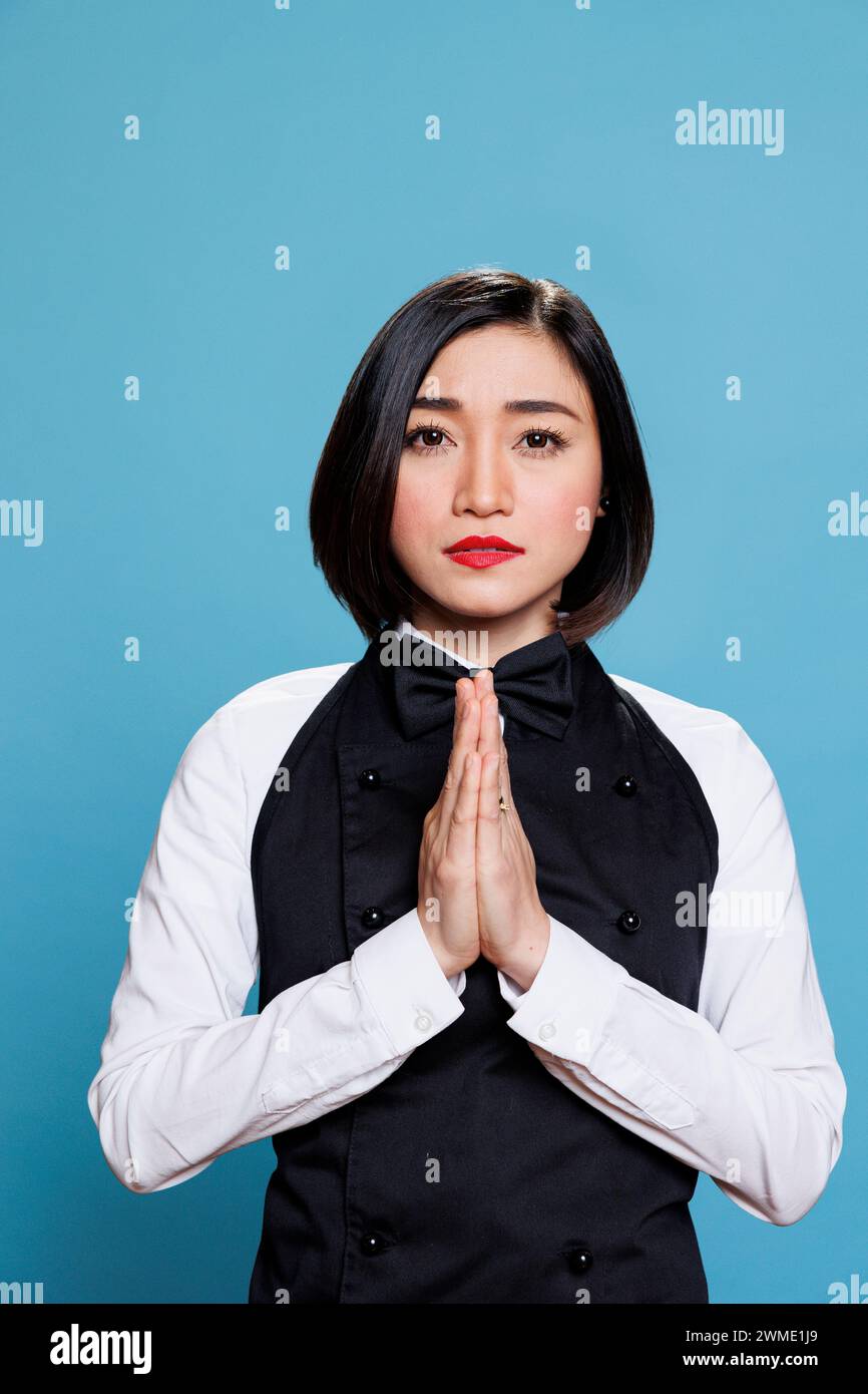 Young asian woman receptionist meditating with folded palms, relaxing ...