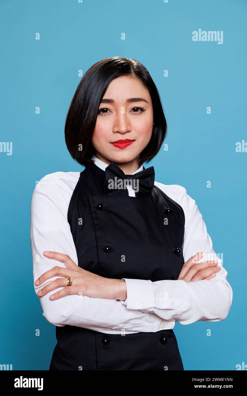 Restaurant woman receptionist wearing uniform smiling while posing with ...