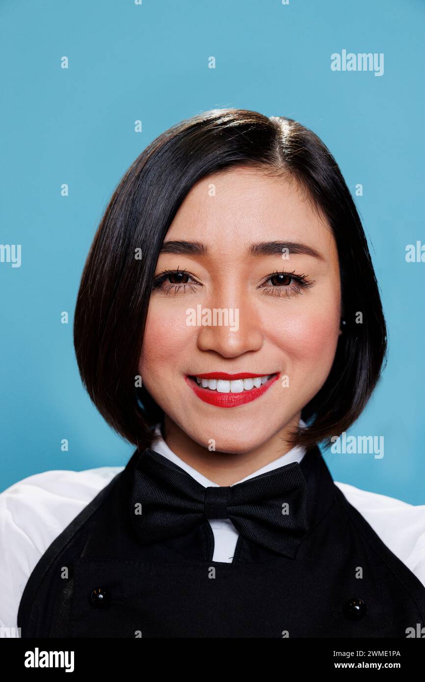Smiling young attractive asian woman wearing waitress black and white ...