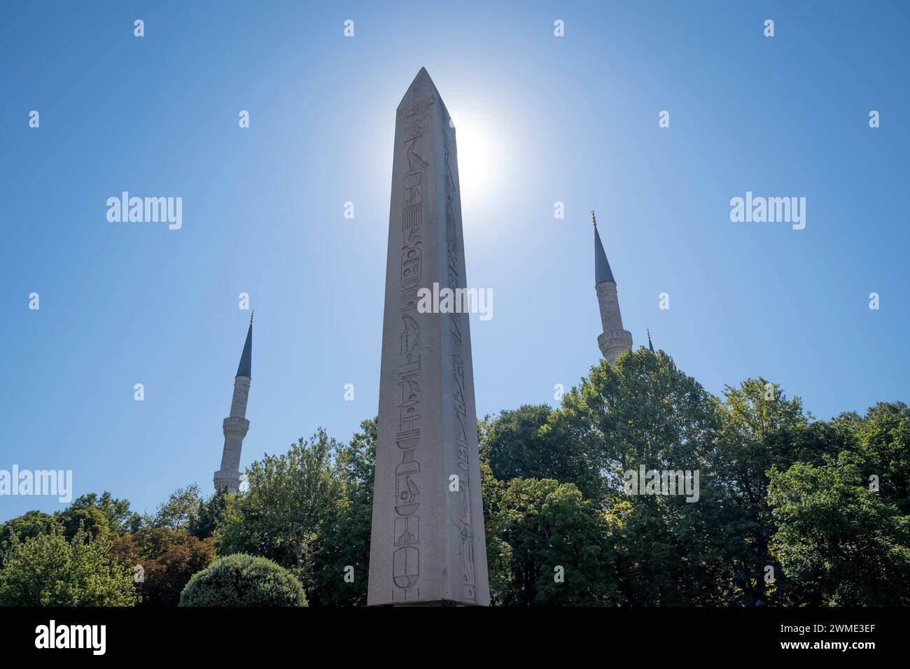 back lit theodosius obelisk in Istanbul with two minarets of the blue ...