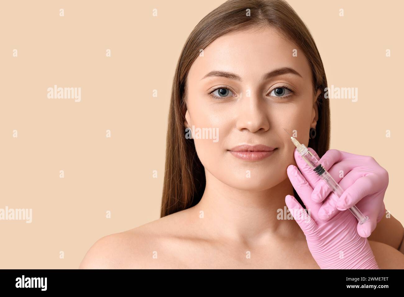 Beautiful woman receiving injection on beige background, closeup Stock ...