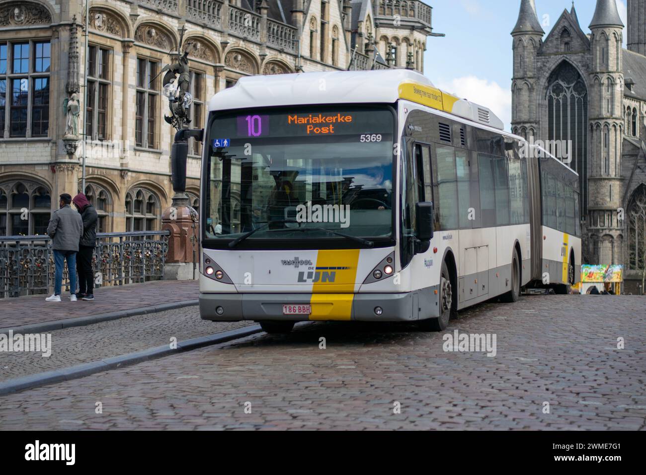 Gent, Belgium - January 31 2024: A flemish De Lijn VanHool city bus in the old inner city of ...