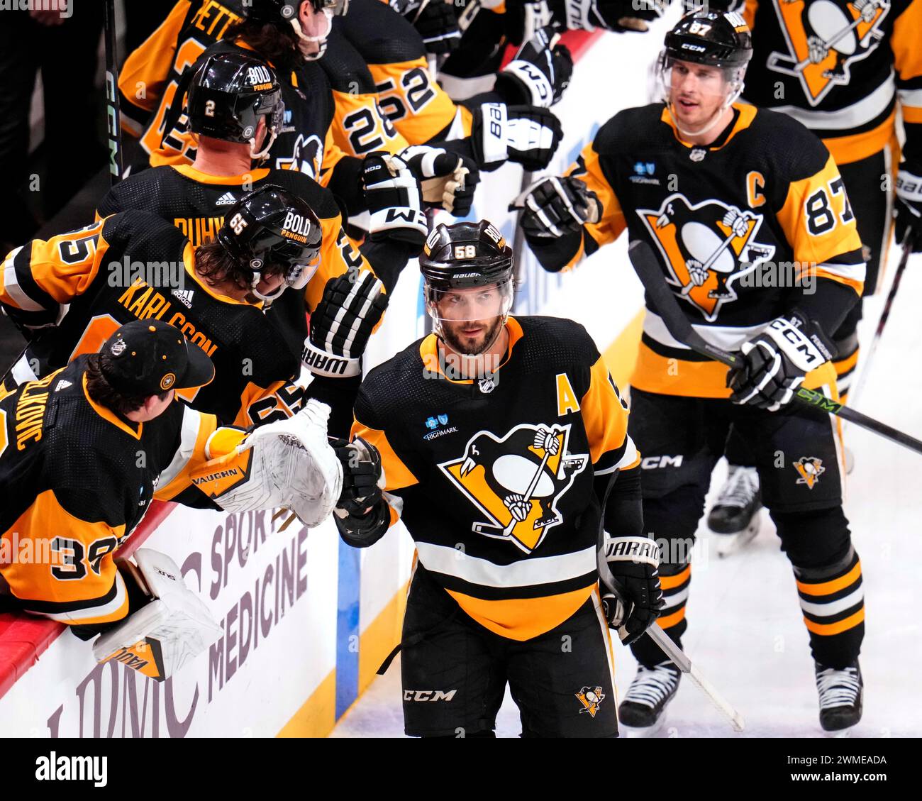 Pittsburgh Penguins' Kris Letang (58) returns to the bench with Sidney ...