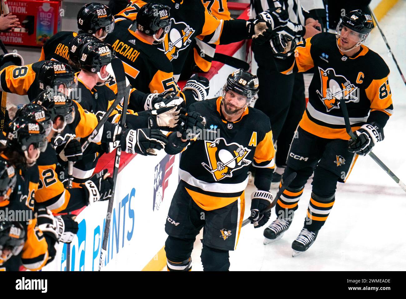 Pittsburgh Penguins' Kris Letang (58) returns to the bench with Sidney ...