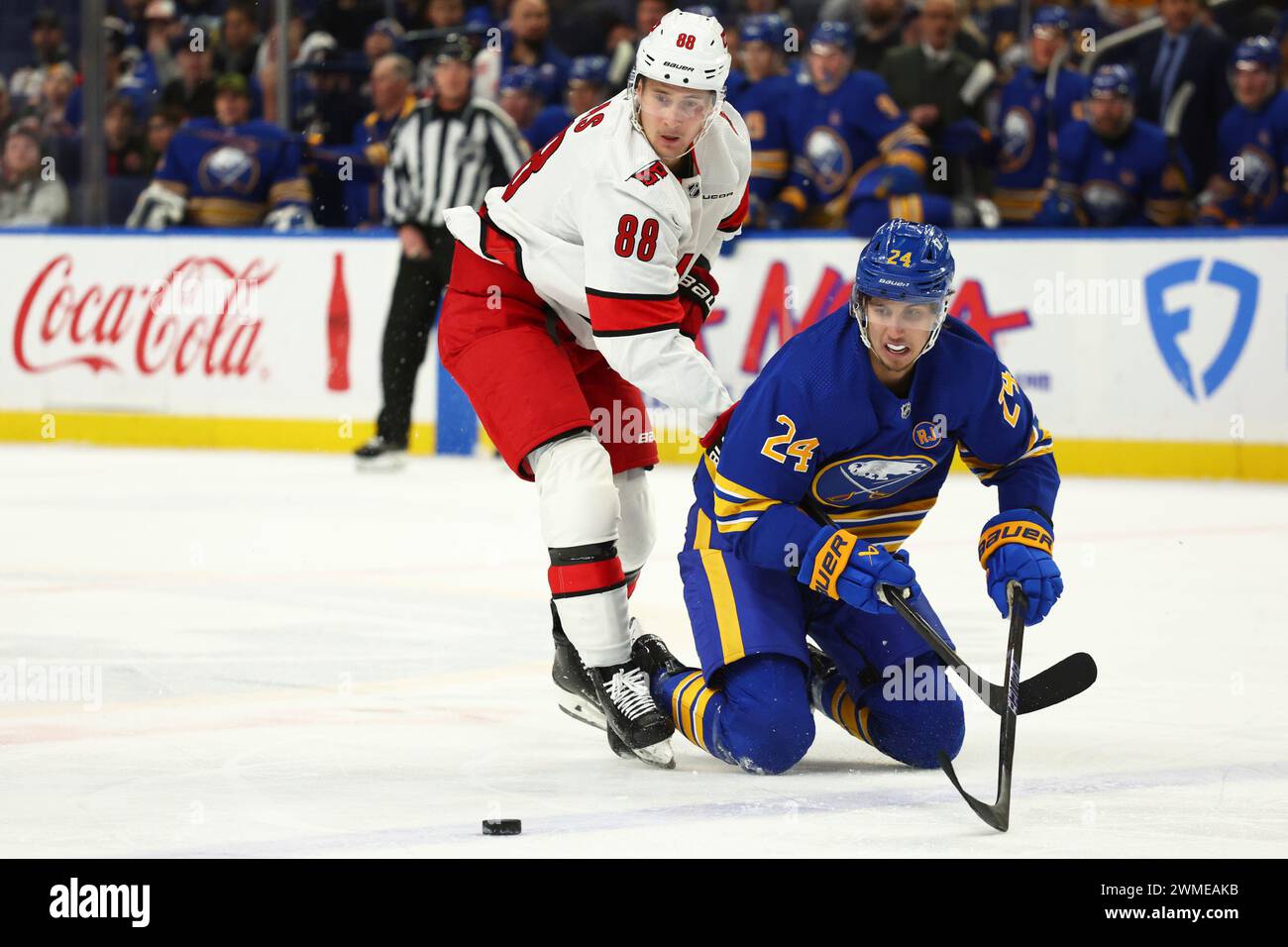 Buffalo Sabres center Dylan Cozens (24) is brought down by Carolina ...