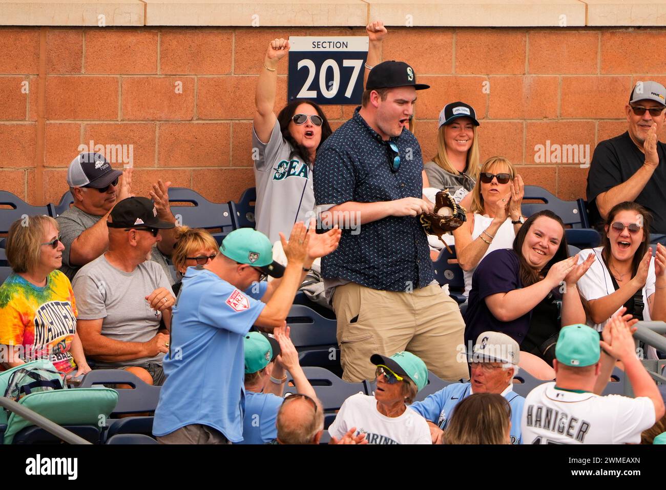 A fan reacts to catching a fly ball during a spring training baseball ...