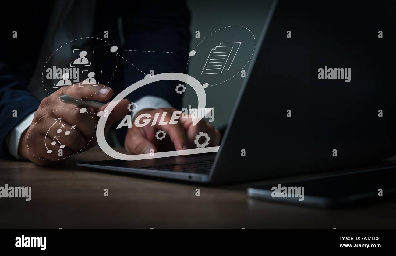 A businessman using a laptop computer Agile management and the ... A businessman using a laptop computer Agile management and the ...